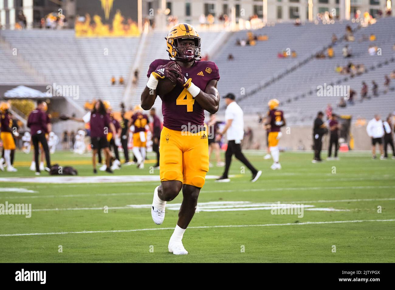 Arizona State running back Daniyel Ngata (4) warms up before an NCAA ...