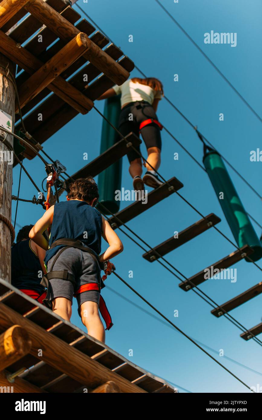 Kids preparing to clear the obstacle in the adventure park Stock Photo ...