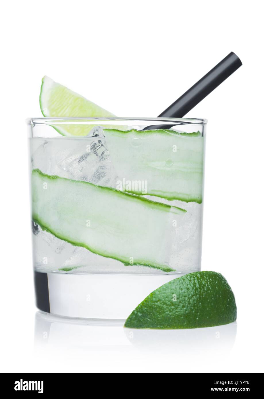 Gimlet cocktail in glass with ice cubes and straw, cucumber and lime ...
