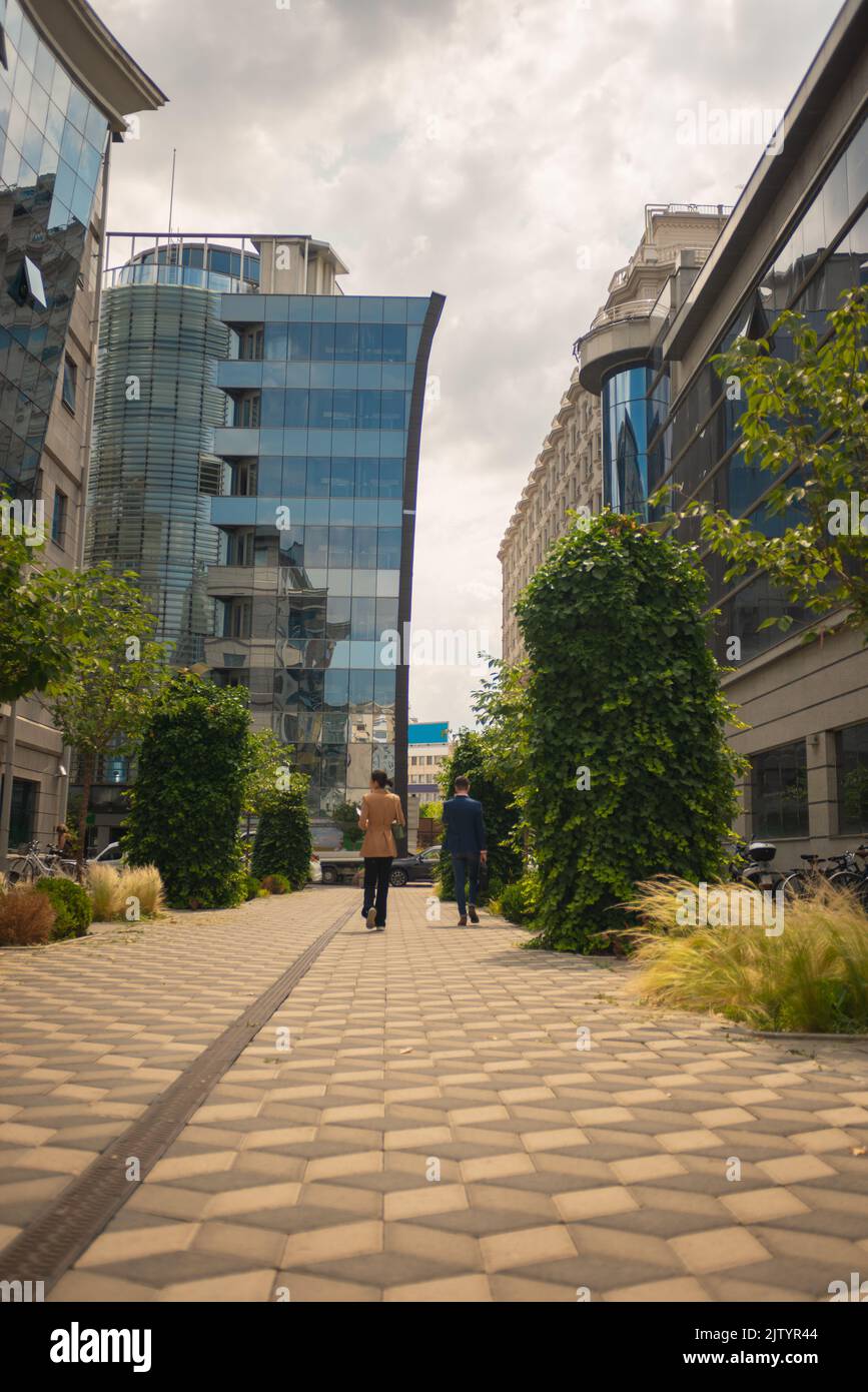 A business couple just finished their work in the city, on a cloudy day ...