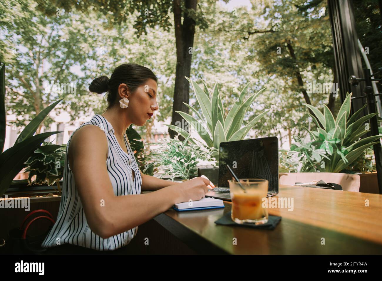 Amazing business woman writting down notes on the notebook while ...