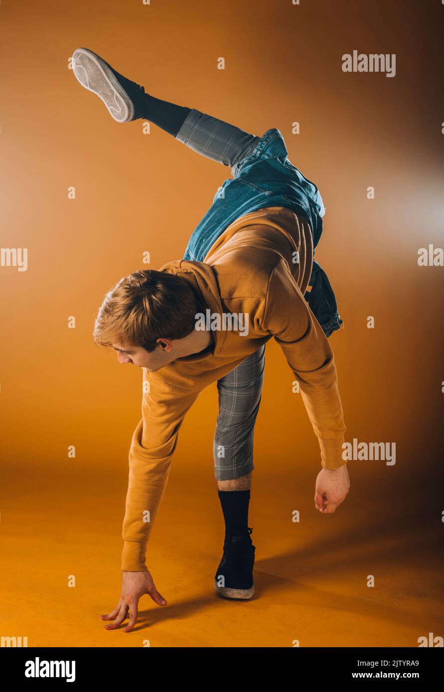 Muscular young guy practicing modern style dance poses Stock Photo - Alamy