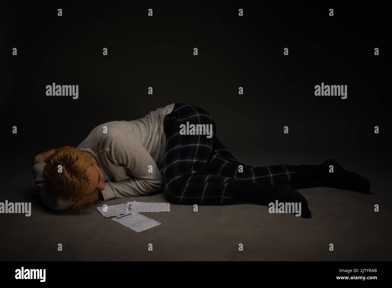 Sad boy is laying and reading the love letter from his love while ...