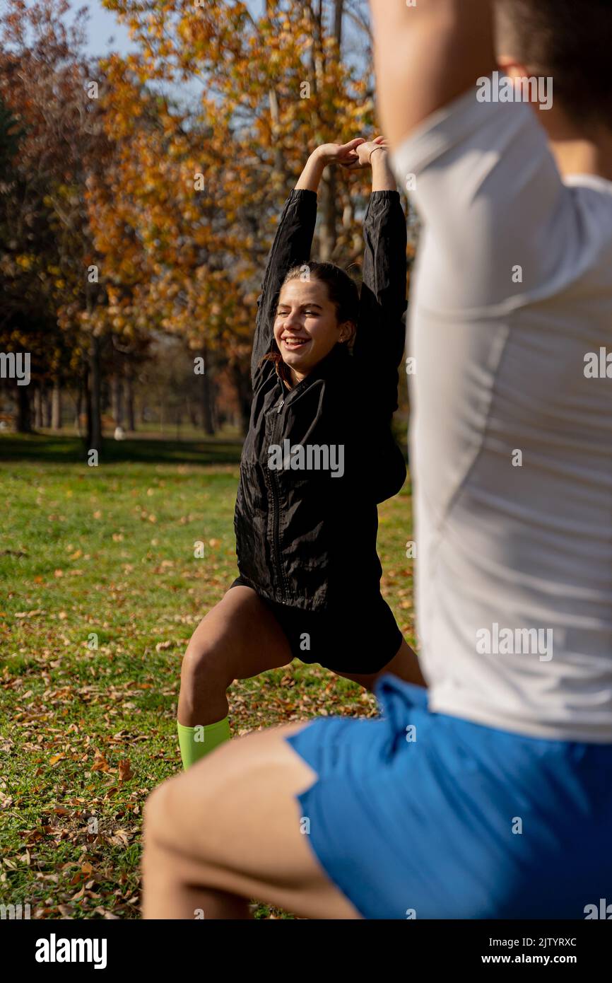 Three attractive and amazing fit friends are stretching and smiling ...