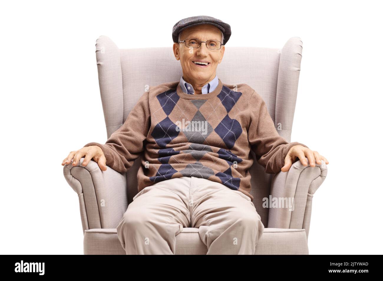 Pensioner sitting in an armchair and smiling at the camera isolated on ...