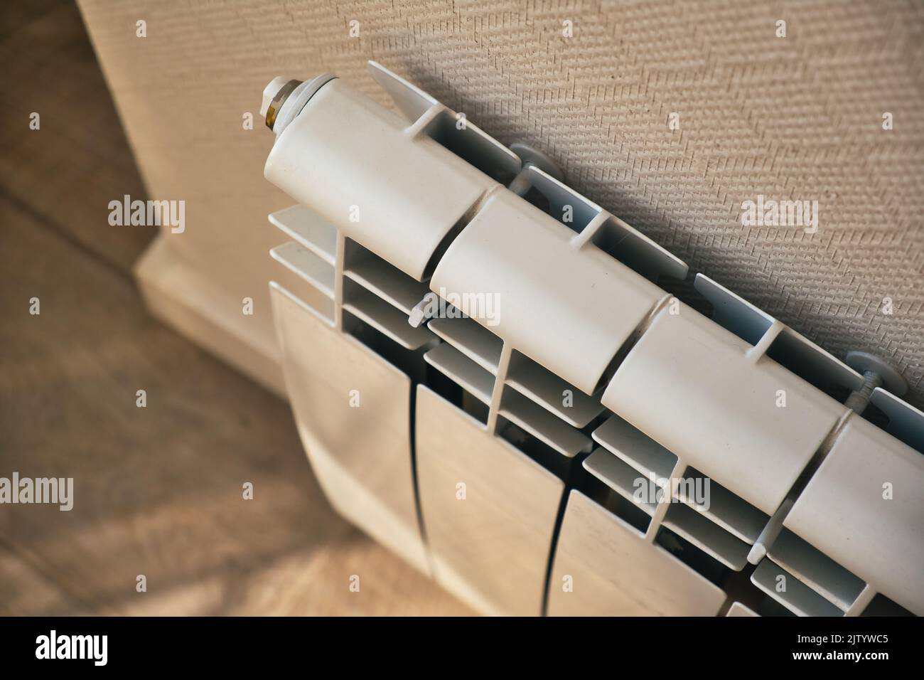 Modern home heating radiator on the wall. Bimetal, aluminium radiator ...