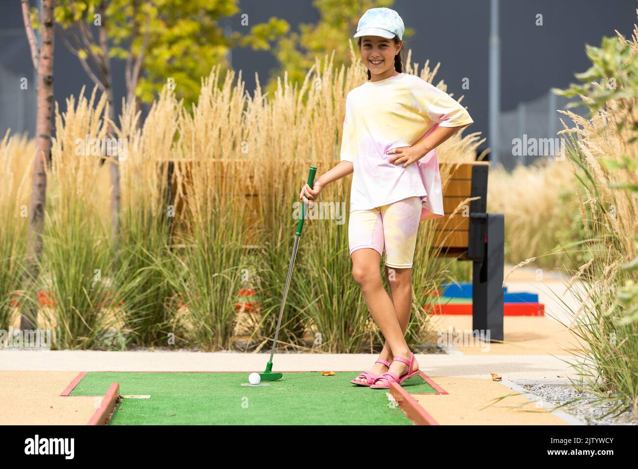 Beautiful little girl playing mini Golf Stock Photo - Alamy