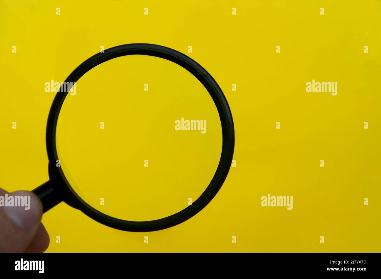 Magnifying glass on wooden desk with space customizable for text or ...