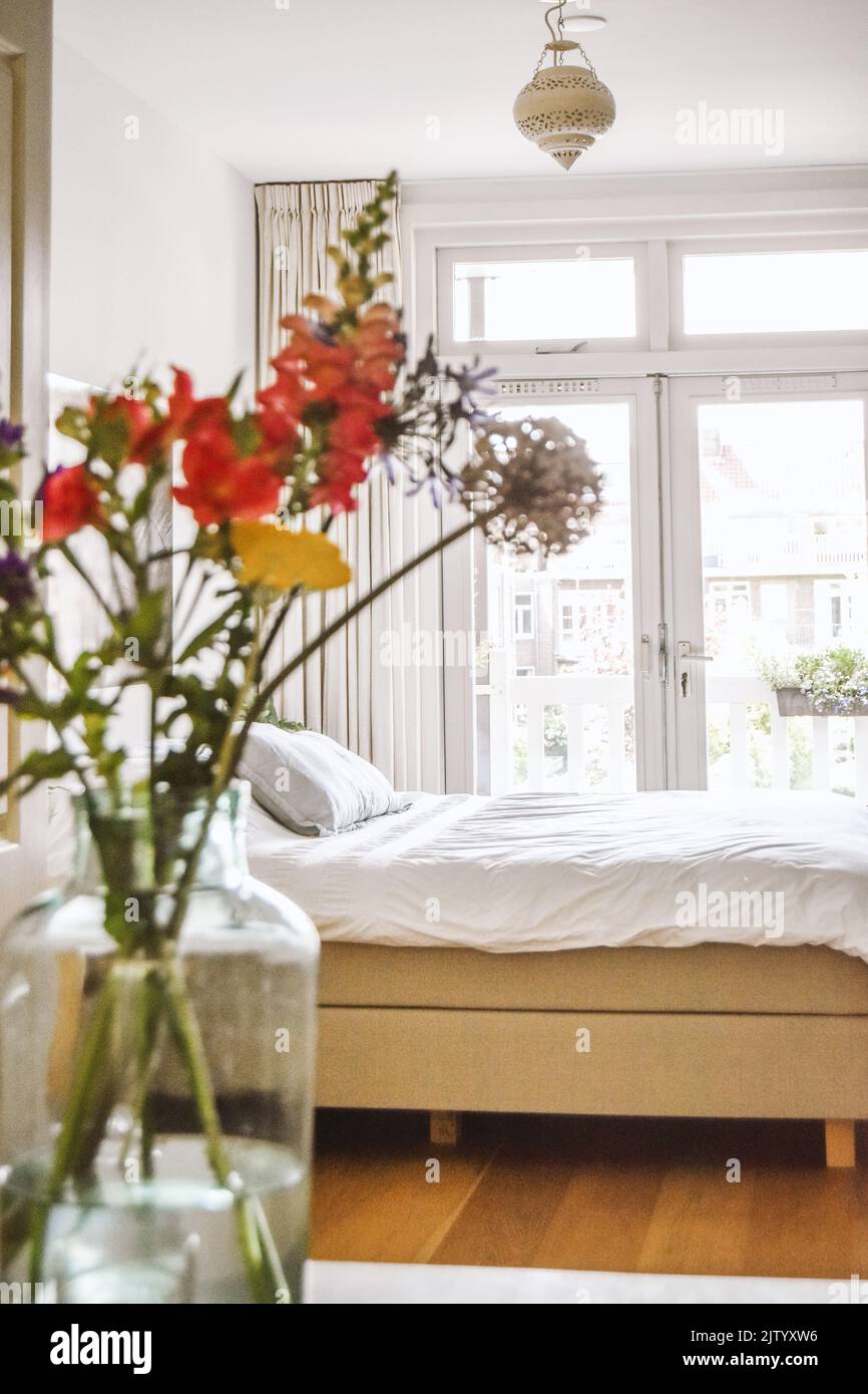 Home interior design of bedroom with bed and wooden wardrobe placed in ...