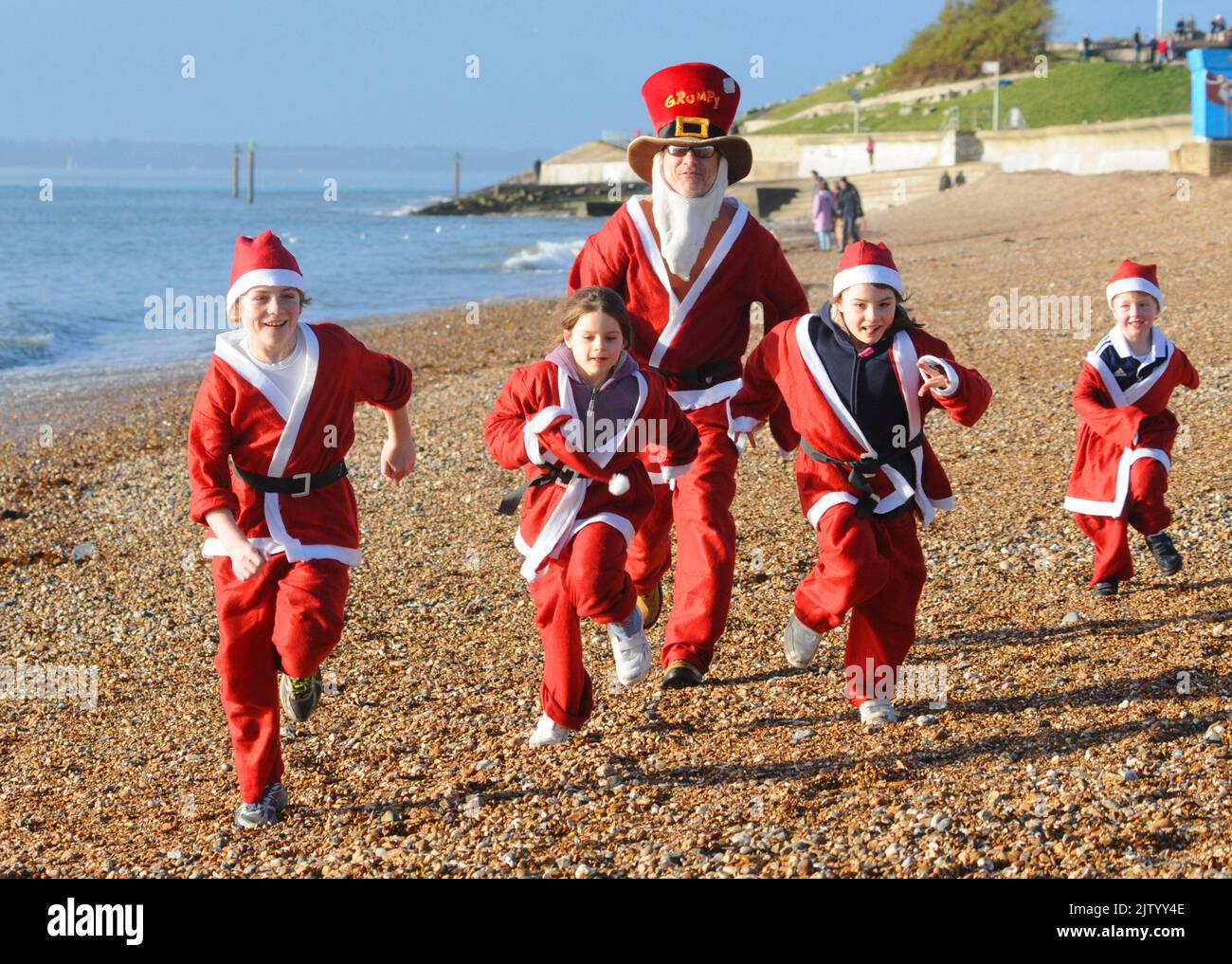 A FAMILY RUN ALONG THE BEACH AT SOUTHSEA AS THEY JOIN HUNDREDS OF OTHER ...