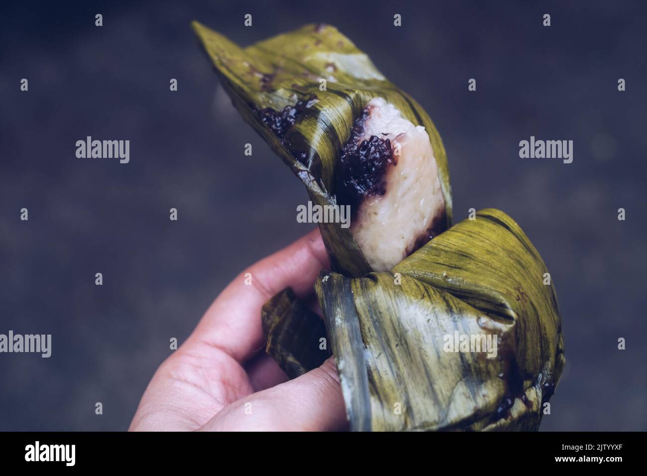 Closeup of hand holding delicious sticky rice cake with chocolate ...