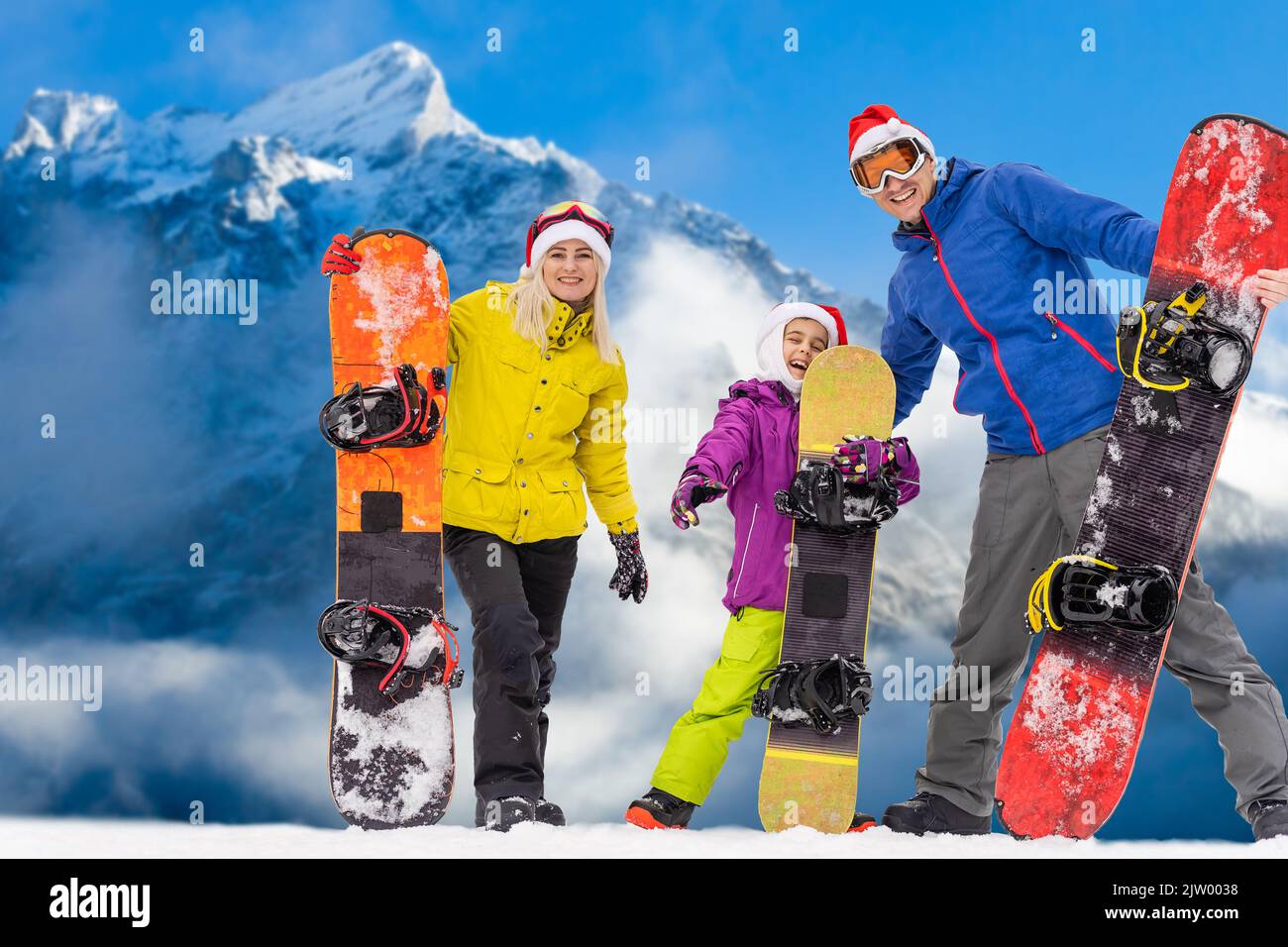 Happy family enjoying winter vacations in mountains. Playing with snow ...