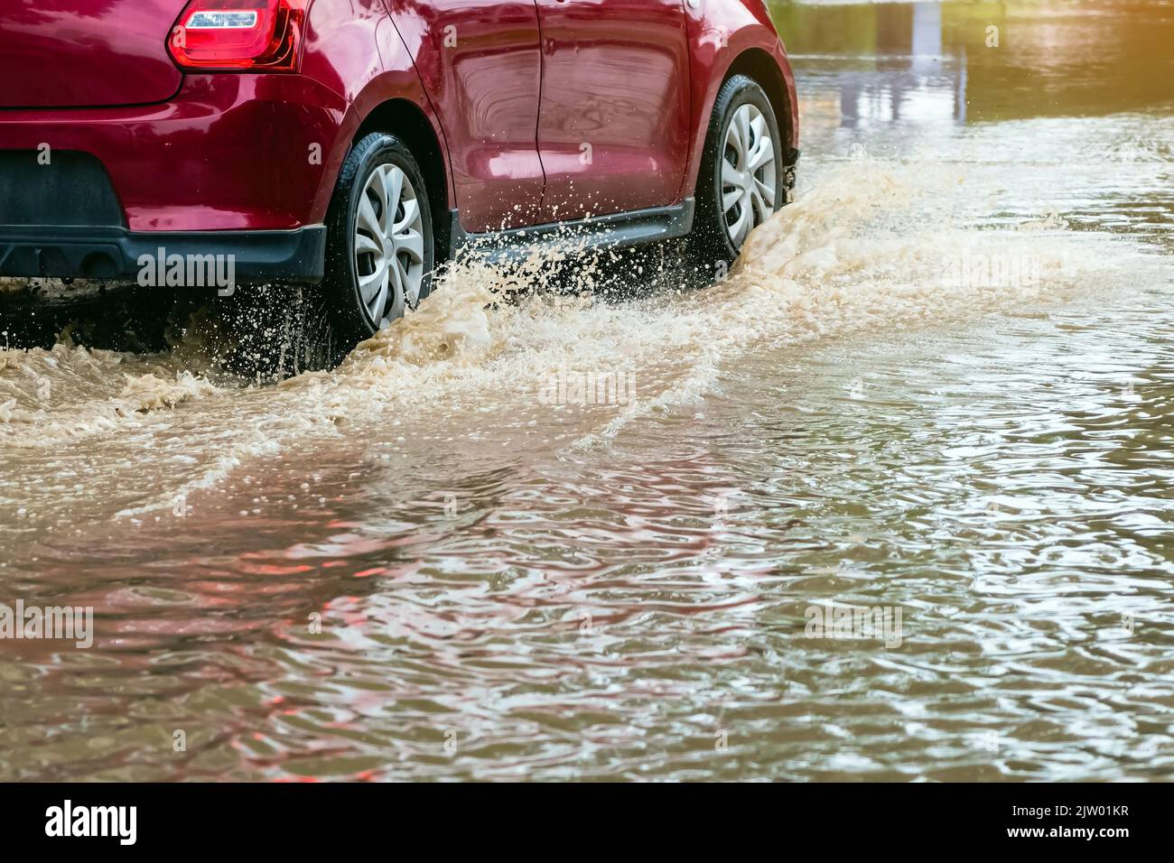 Car passing through a flooded road. Driving car on flooded road during ...