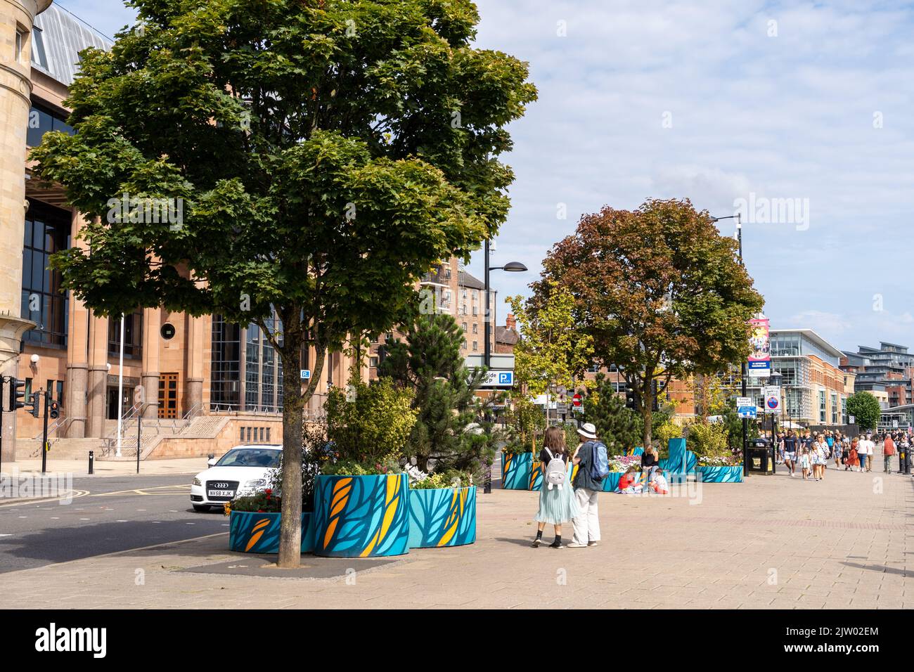 People enjoying a walk along the waterfront or Quayside in the city of ...