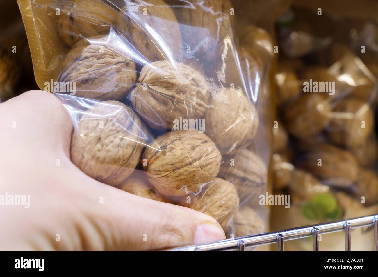 Packaged snacks walnuts on the shelves of the hypermarket. A healthy ...