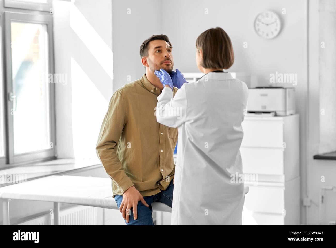 doctor checking lymph nodes of man at hospital Stock Photo - Alamy