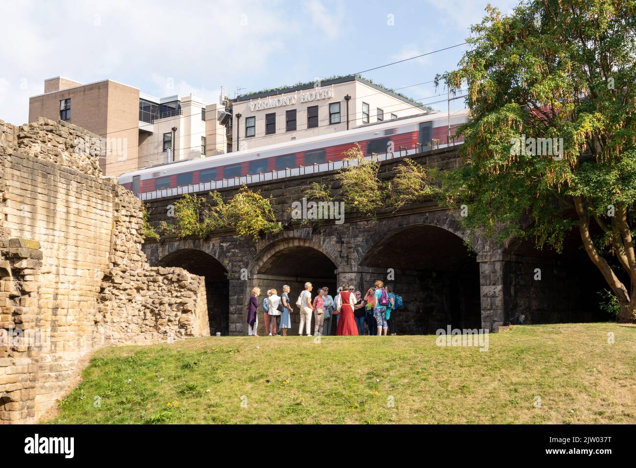 An LNER train flies past Newcastle Castle, where a costumed guide ...