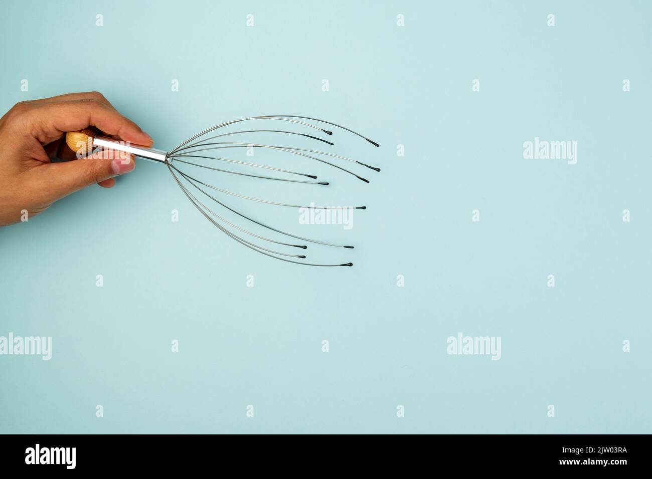 A head massager. Manual device for home and professional massage. Blue ...