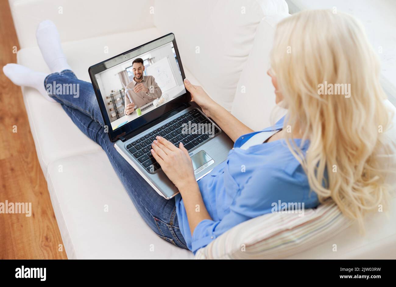 woman with laptop watching tutorial video at home Stock Photo - Alamy