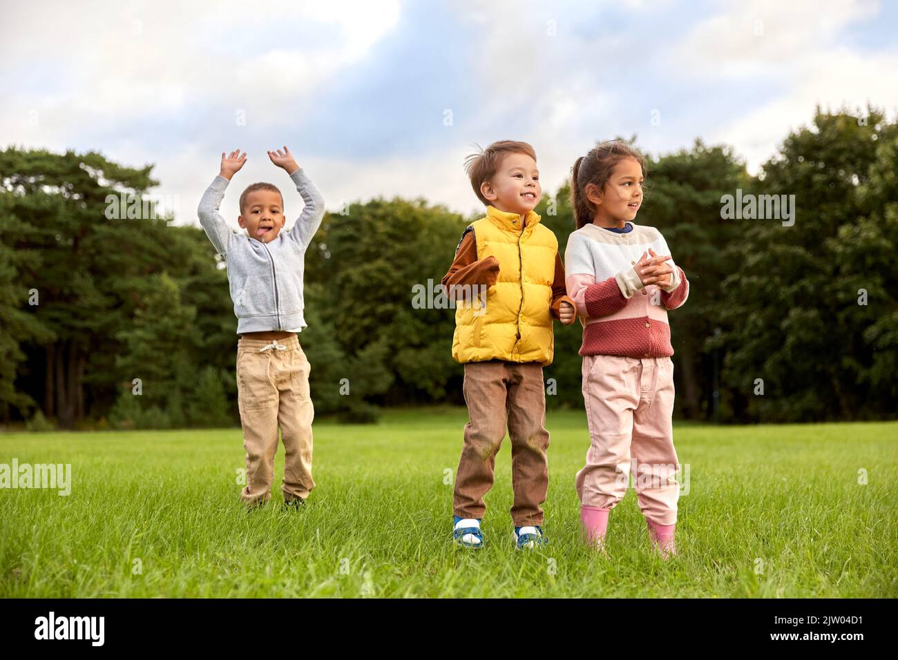 happy children playing and jumping at park Stock Photo - Alamy