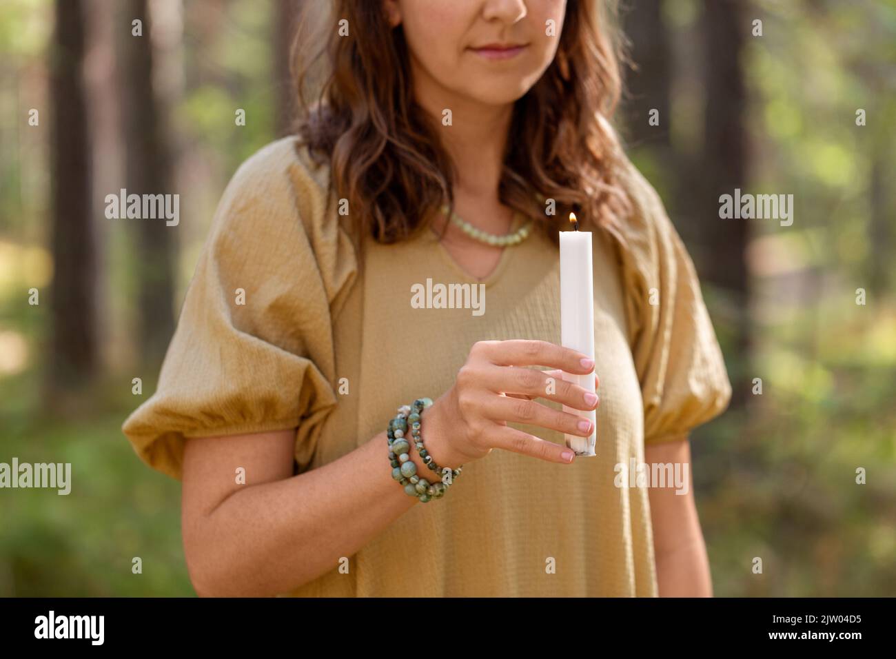 woman with candle performing magic ritual Stock Photo - Alamy