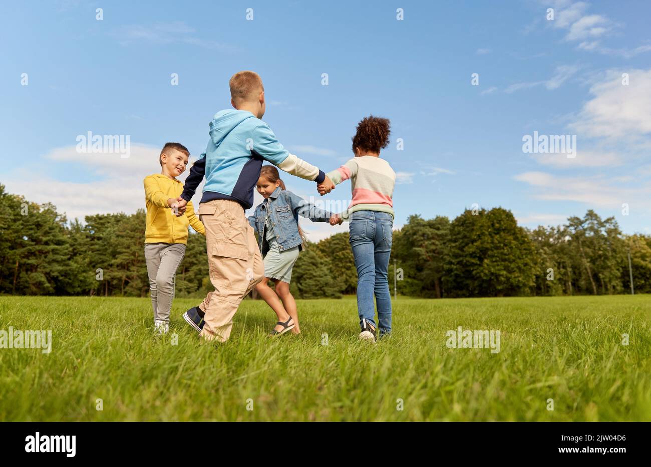 happy children playing round dance at park Stock Photo - Alamy
