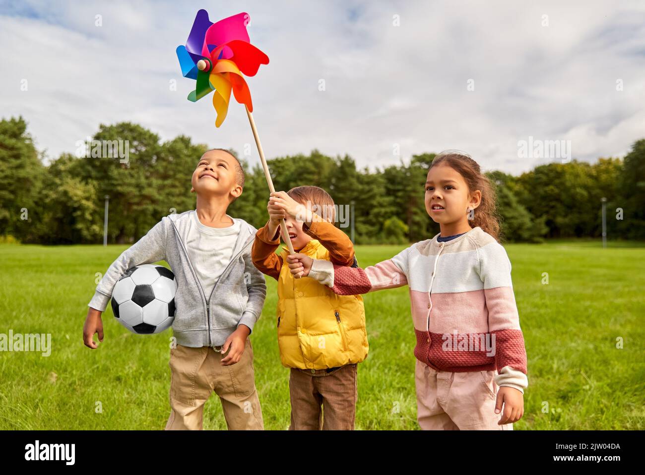 happy children playing with pinwheel at park Stock Photo - Alamy