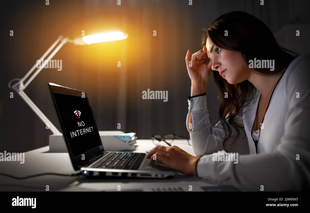 sad woman having no internet on laptop at office Stock Photo - Alamy