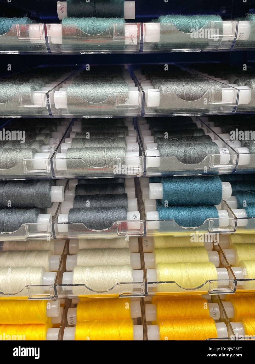 Sewing threads multi colored background. Colorful thread spools used in ...