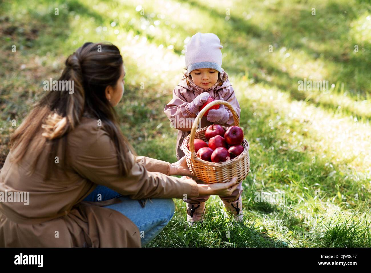mother and baby daughter with basket of apples Stock Photo - Alamy