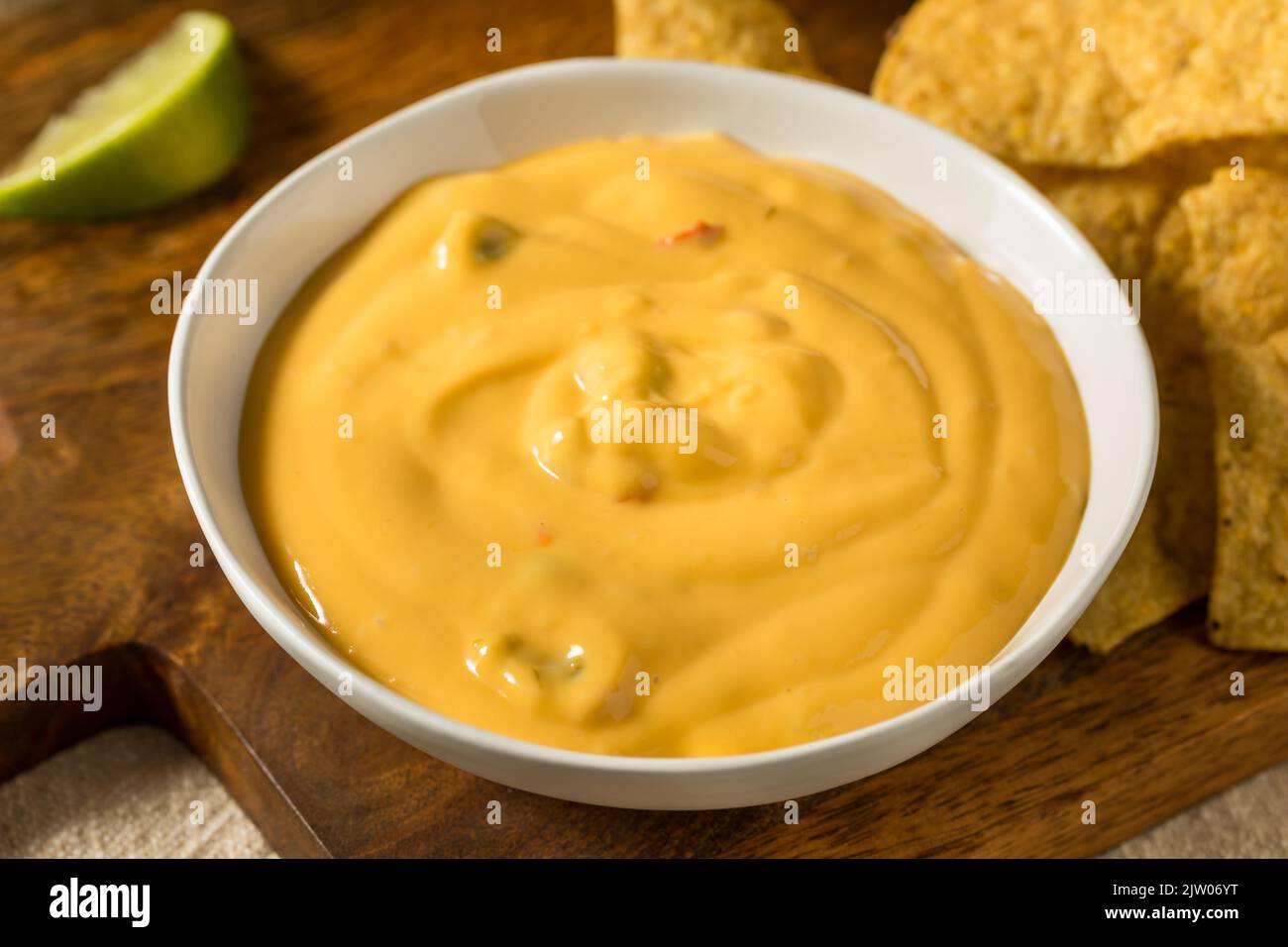 Homemade Yellow Queso Cheese Dip with Tortilla Chips and Lime Stock ...