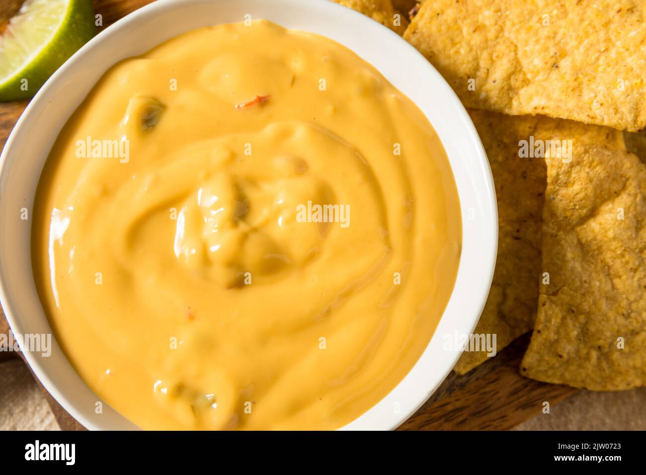 Homemade Yellow Queso Cheese Dip with Tortilla Chips and Lime Stock ...