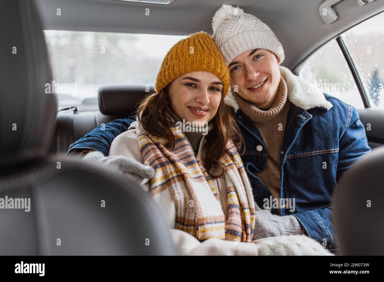 happy smiling couple on car back seat in winter Stock Photo - Alamy