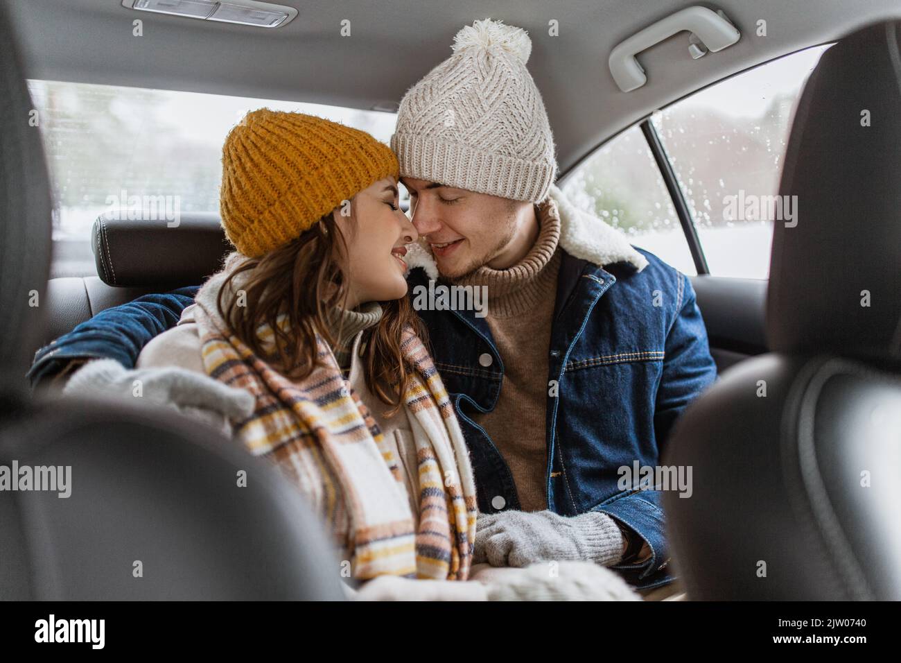 happy smiling couple on car back seat in winter Stock Photo - Alamy