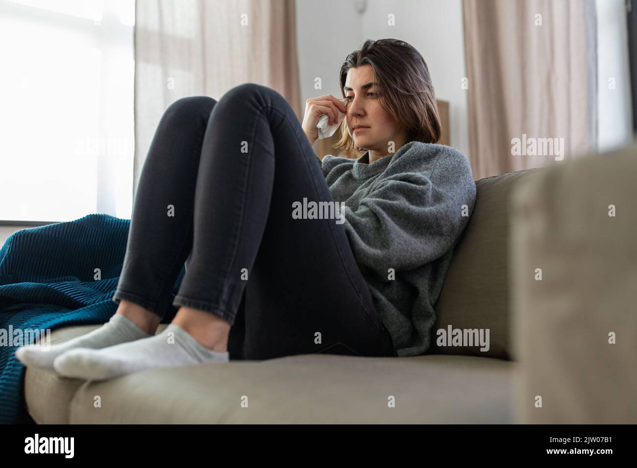 Sad crying depressed woman sitting hi-res stock photography and images ...