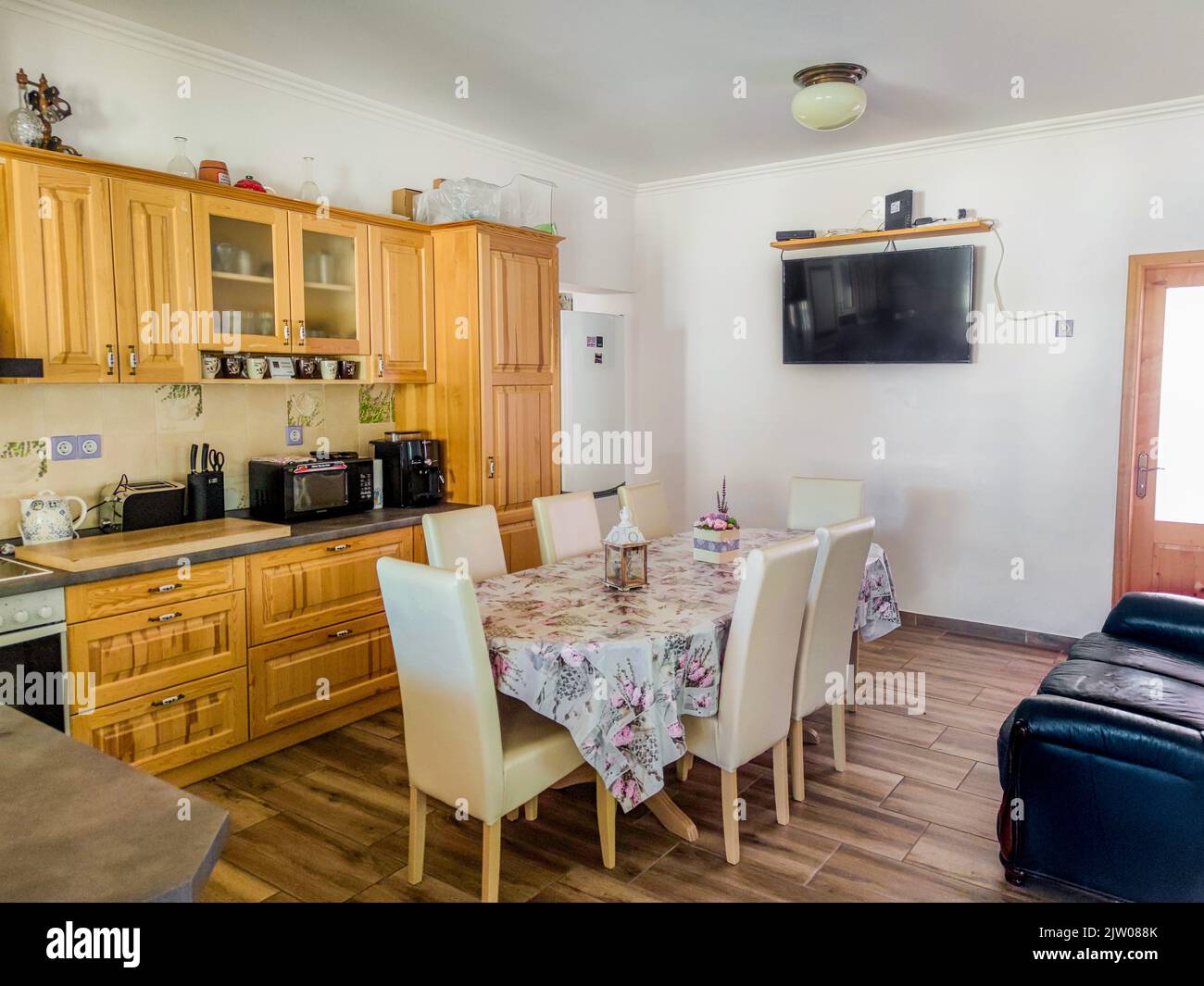 Average modern equipped good-looking kitchen dinner table in the middle ...