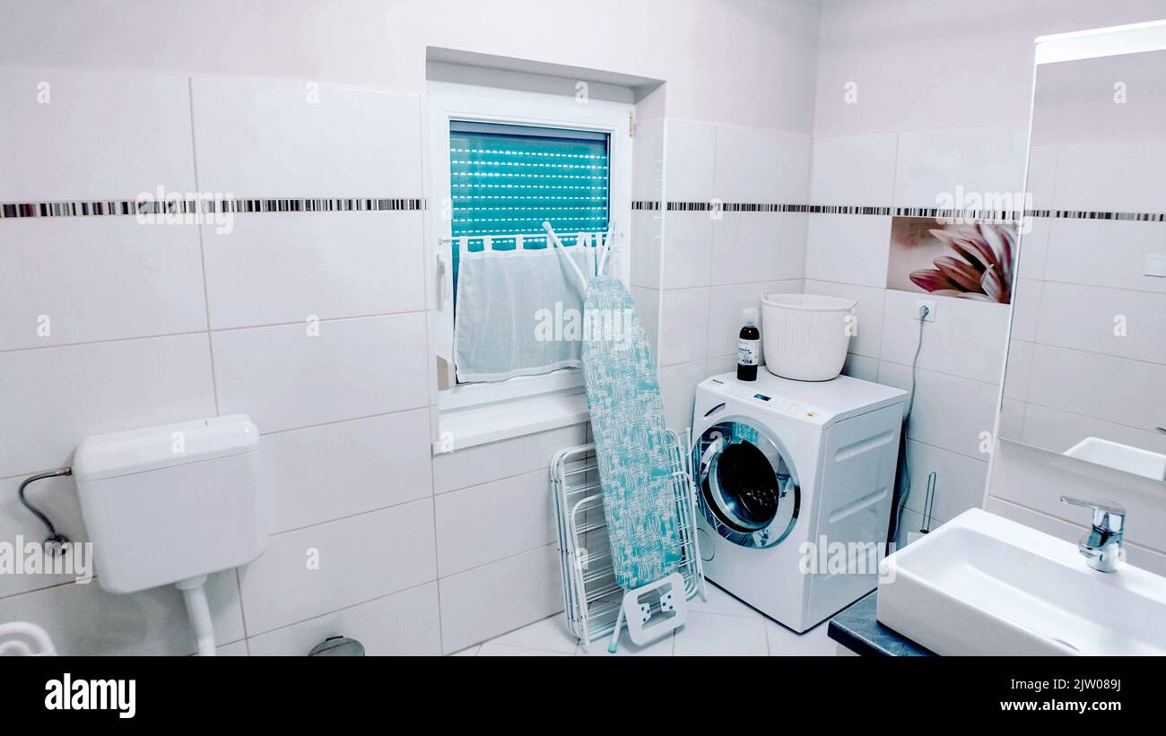 Average washing room with ironing board leaning against the wall Stock ...