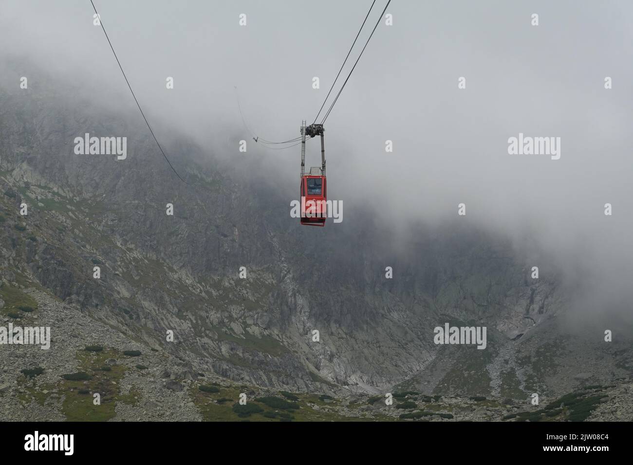 Cable car disappearing into the clouds on its journey to Lomnicky Stit ...