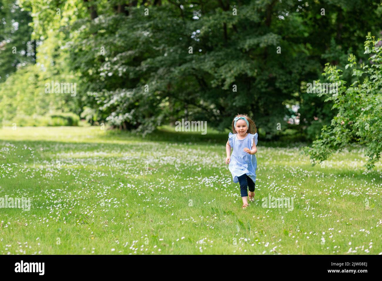 happy little girl running at park in summer Stock Photo - Alamy