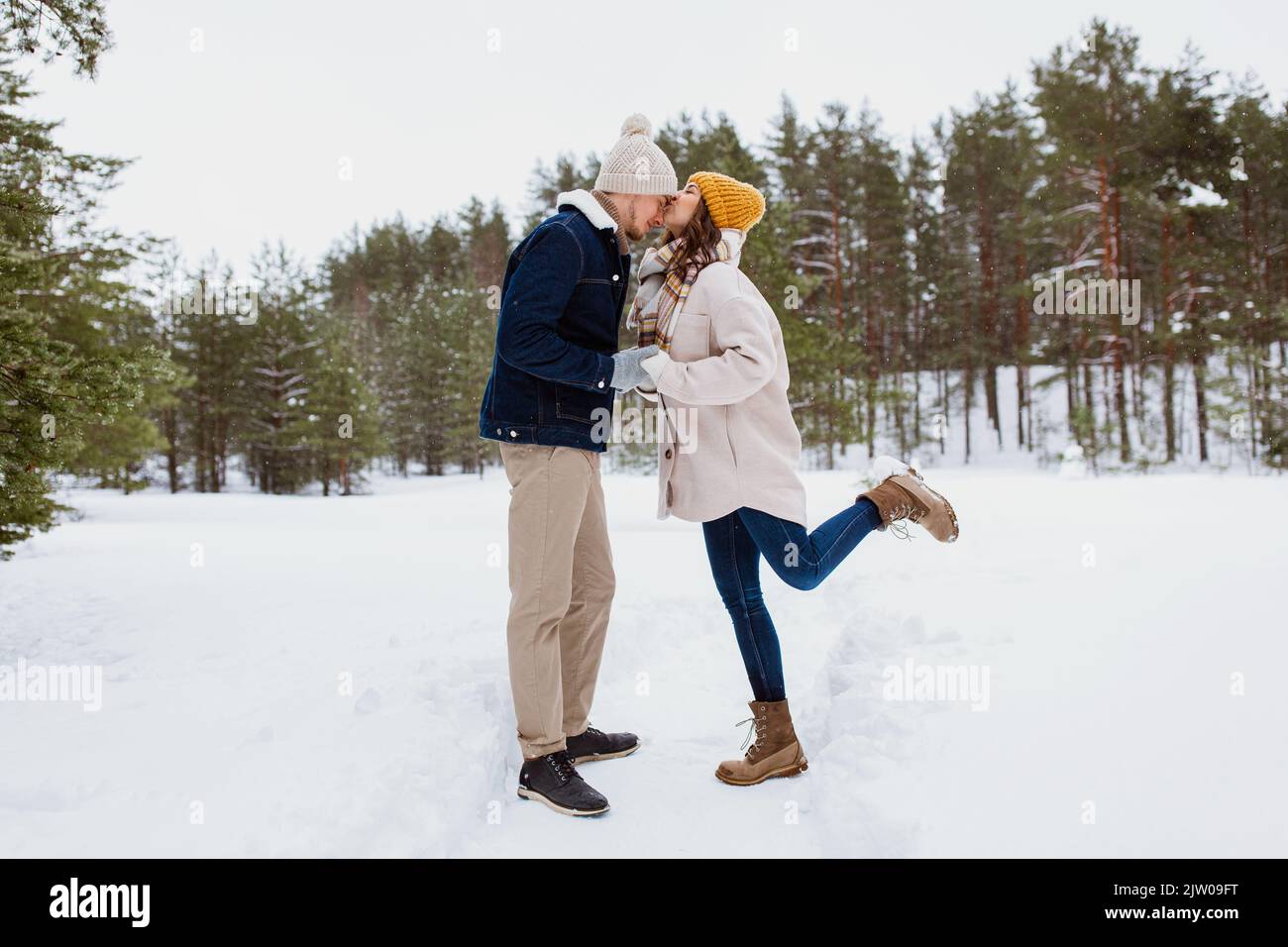 happy woman kissing man to forehead in winter Stock Photo - Alamy