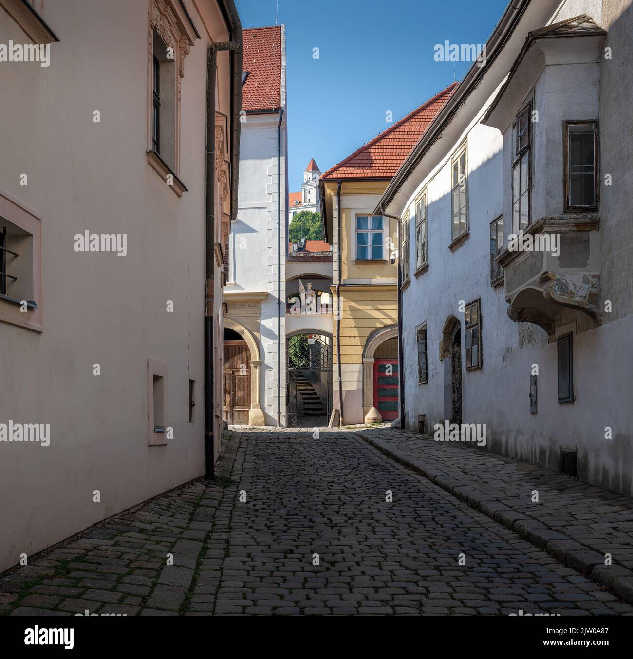 Old Town alley street with Bratislava Castle on background - Bratislava ...
