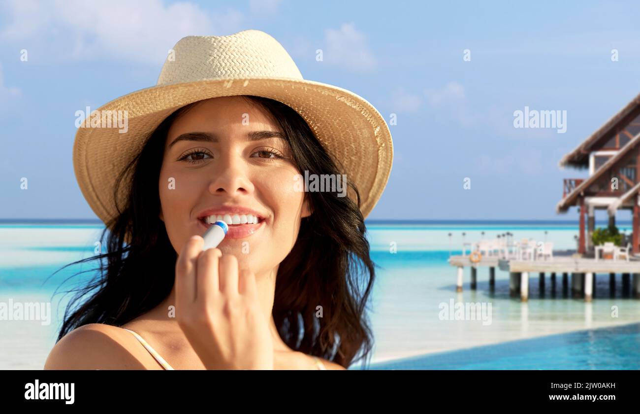 smiling woman in bikini with lip balm on beach Stock Photo - Alamy