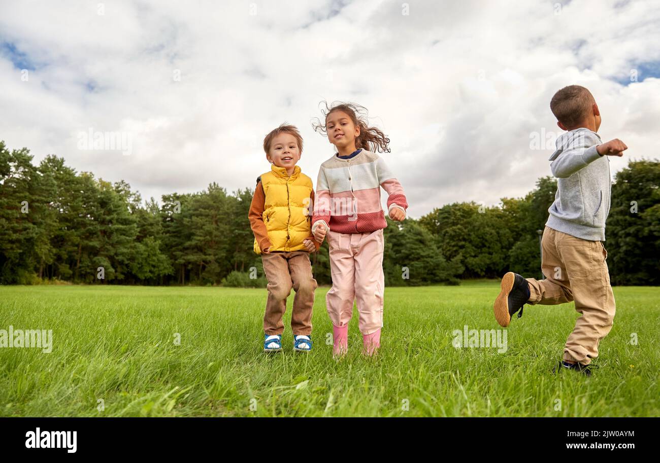 happy children playing and jumping at park Stock Photo - Alamy