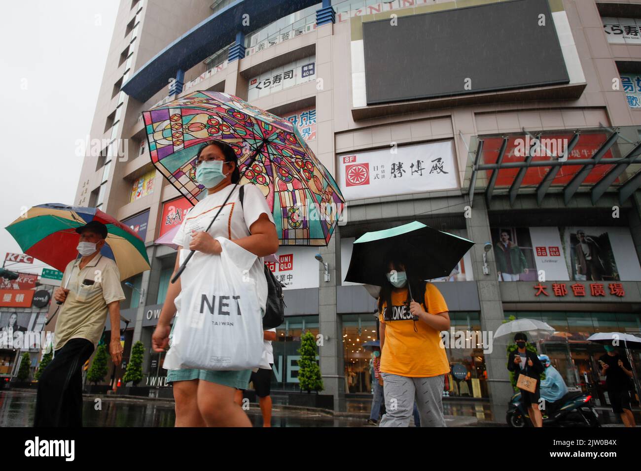 Taipei, Taiwan. 2nd Sep, 2022. People holding up umbrellas walk under ...