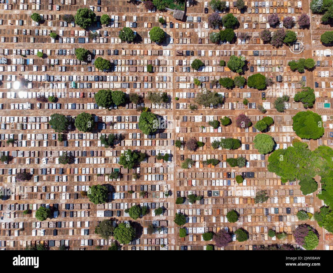 Scenic aerial flight directly above densely packed cemetery graveyard ...