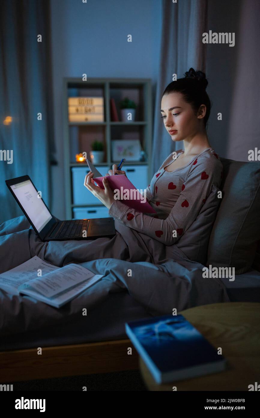 student girl with notebook and laptop at night Stock Photo - Alamy