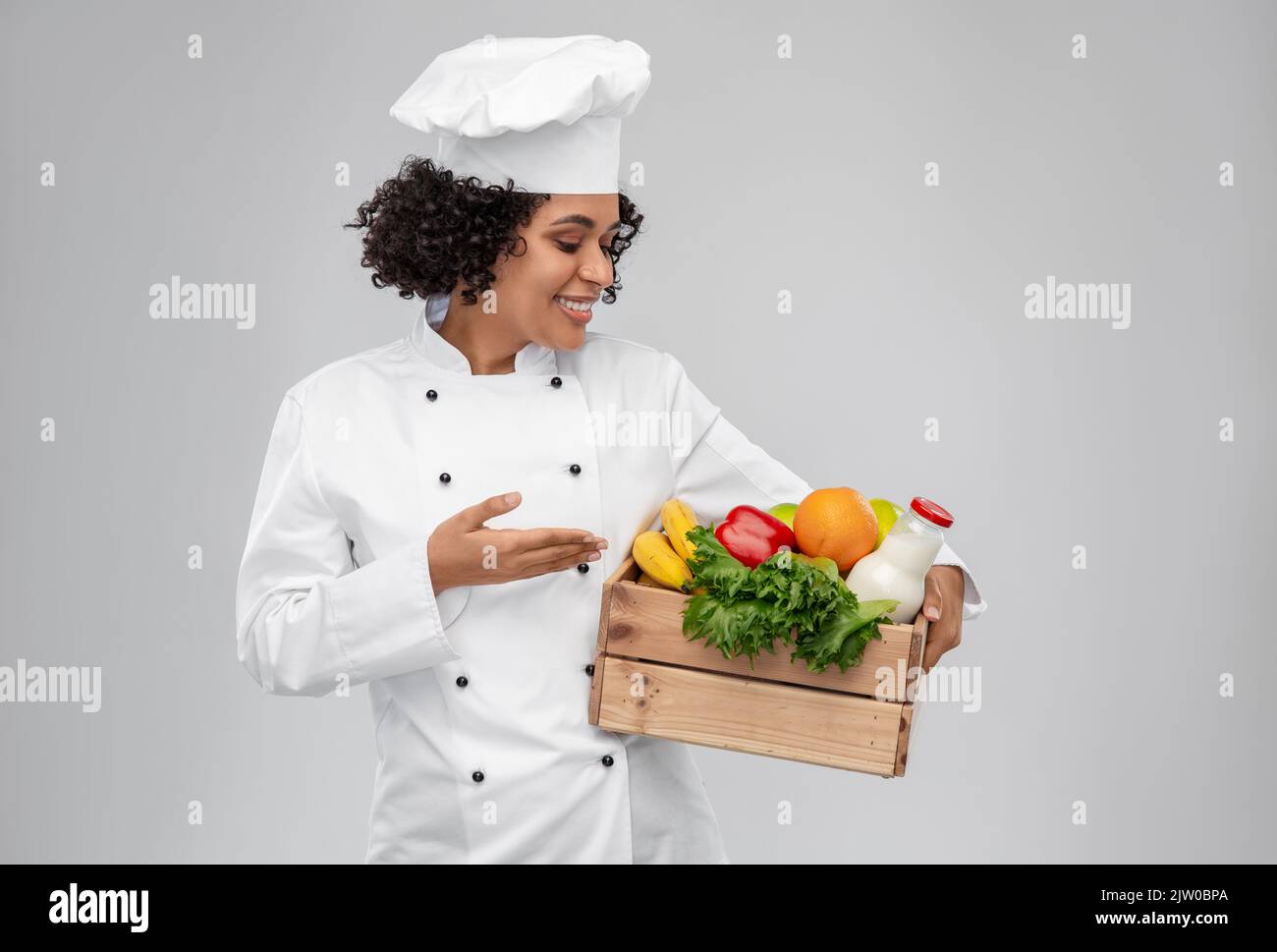 happy smiling female chef with food in wooden box Stock Photo - Alamy