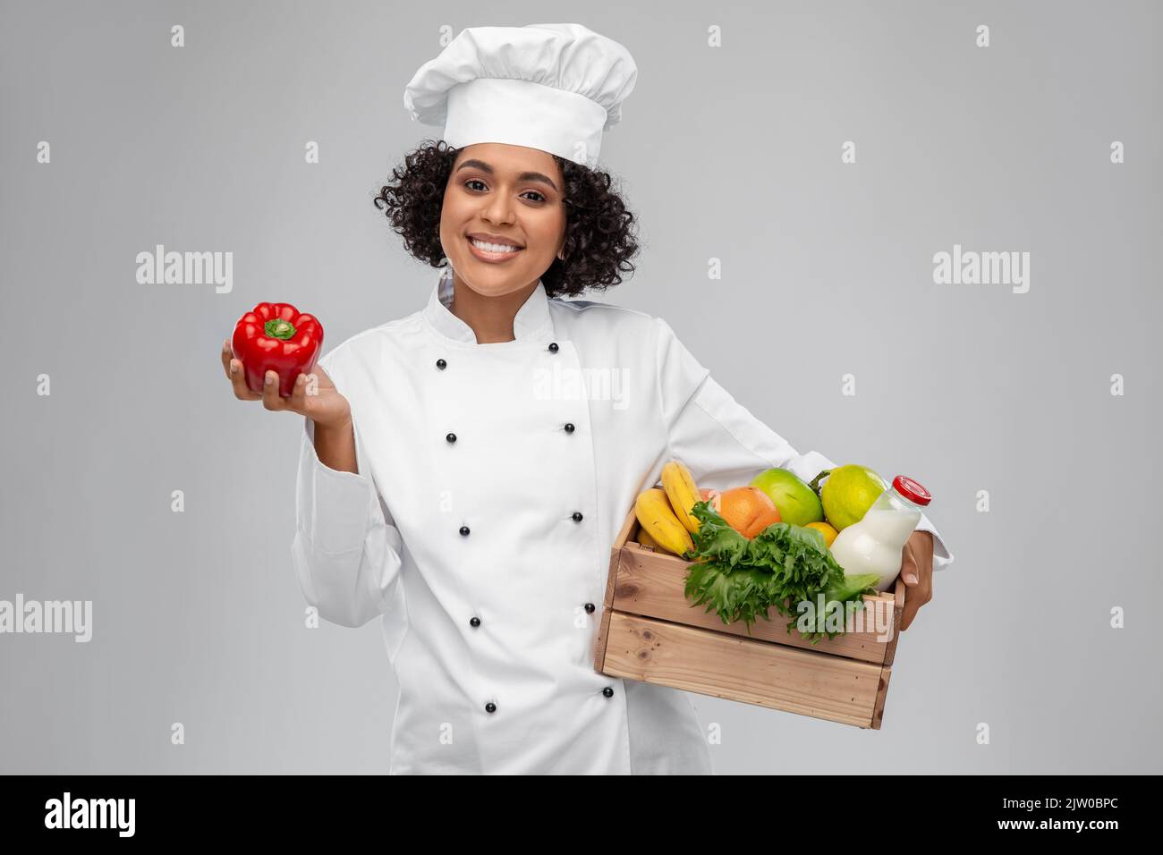 happy smiling female chef with food in wooden box Stock Photo - Alamy