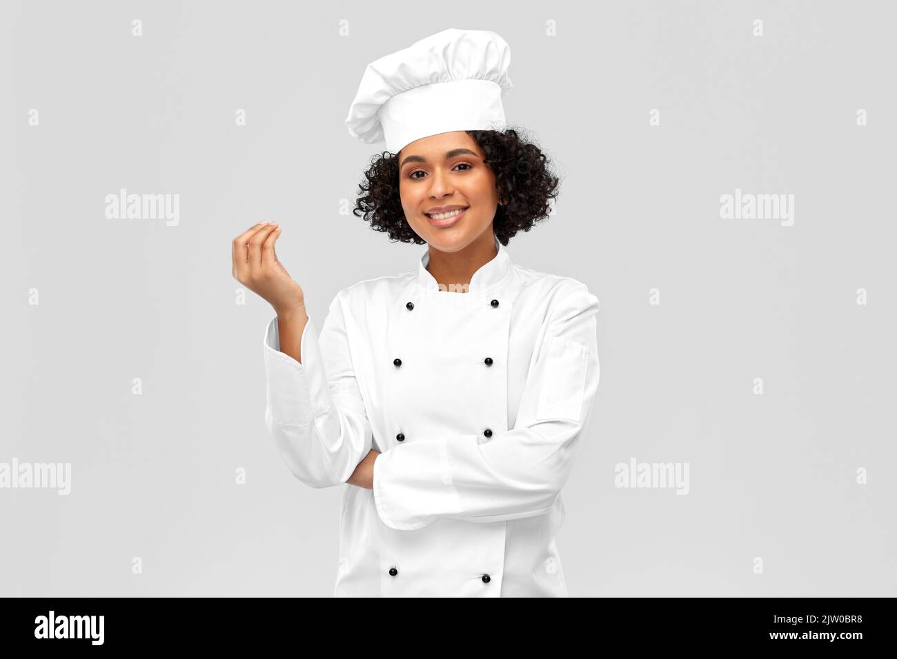 happy female chef showing gourmet sign Stock Photo - Alamy
