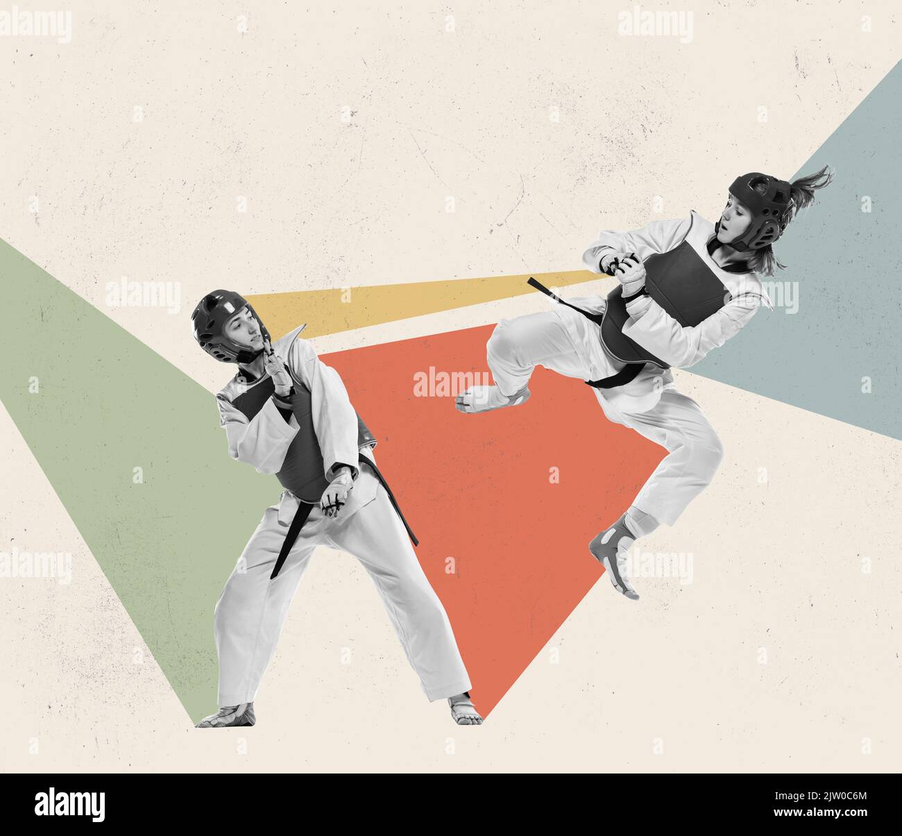 Jumping kick. Two young women, taekwondo practitioners training ...